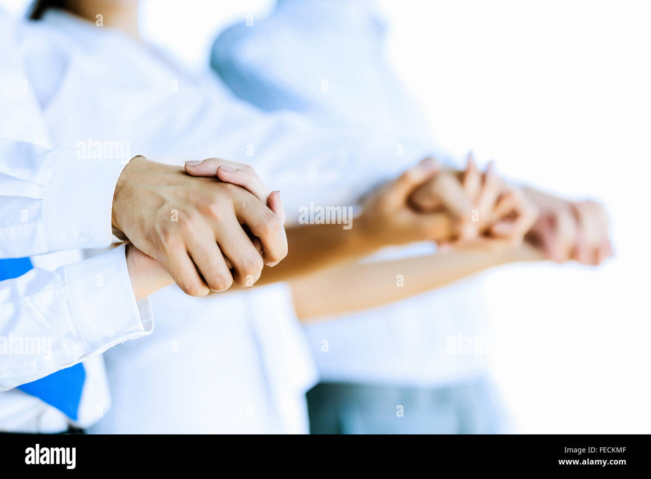 Image of group of businesspeople holding arms together. Teamwork Stock ...