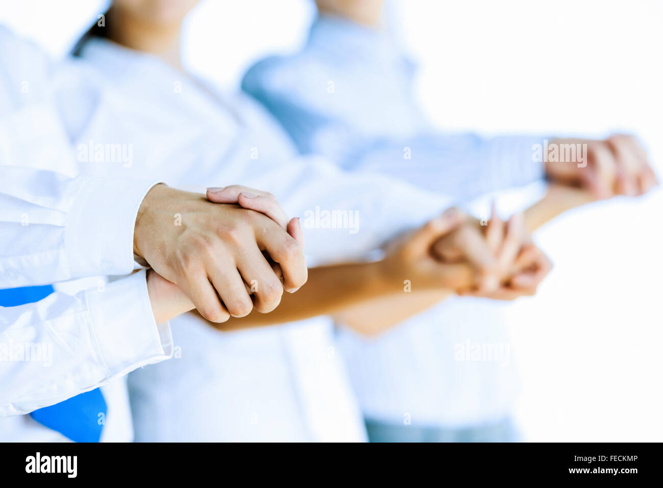 Image of group of businesspeople holding arms together. Teamwork Stock ...