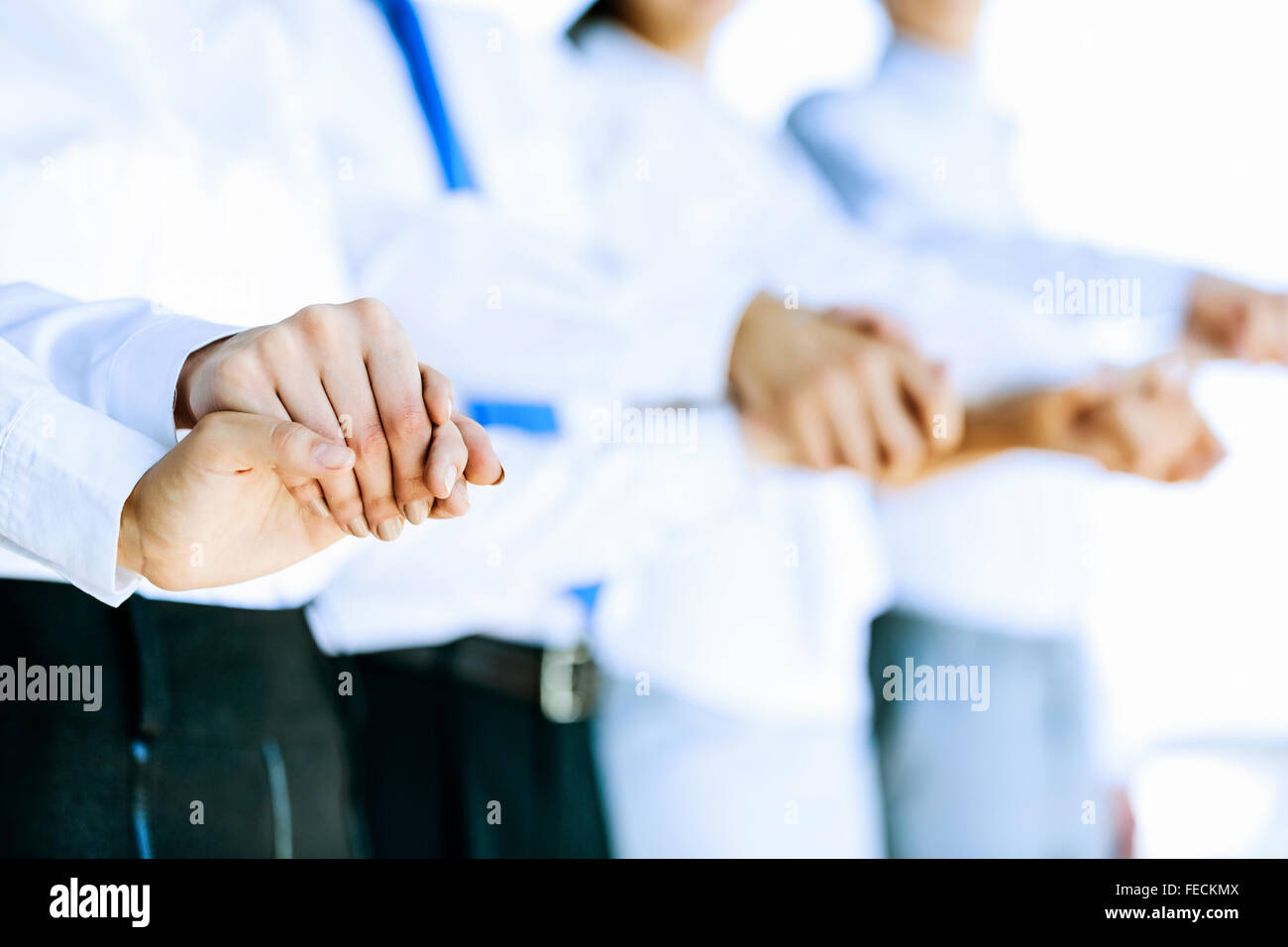 Image of group of businesspeople holding arms together. Teamwork Stock ...