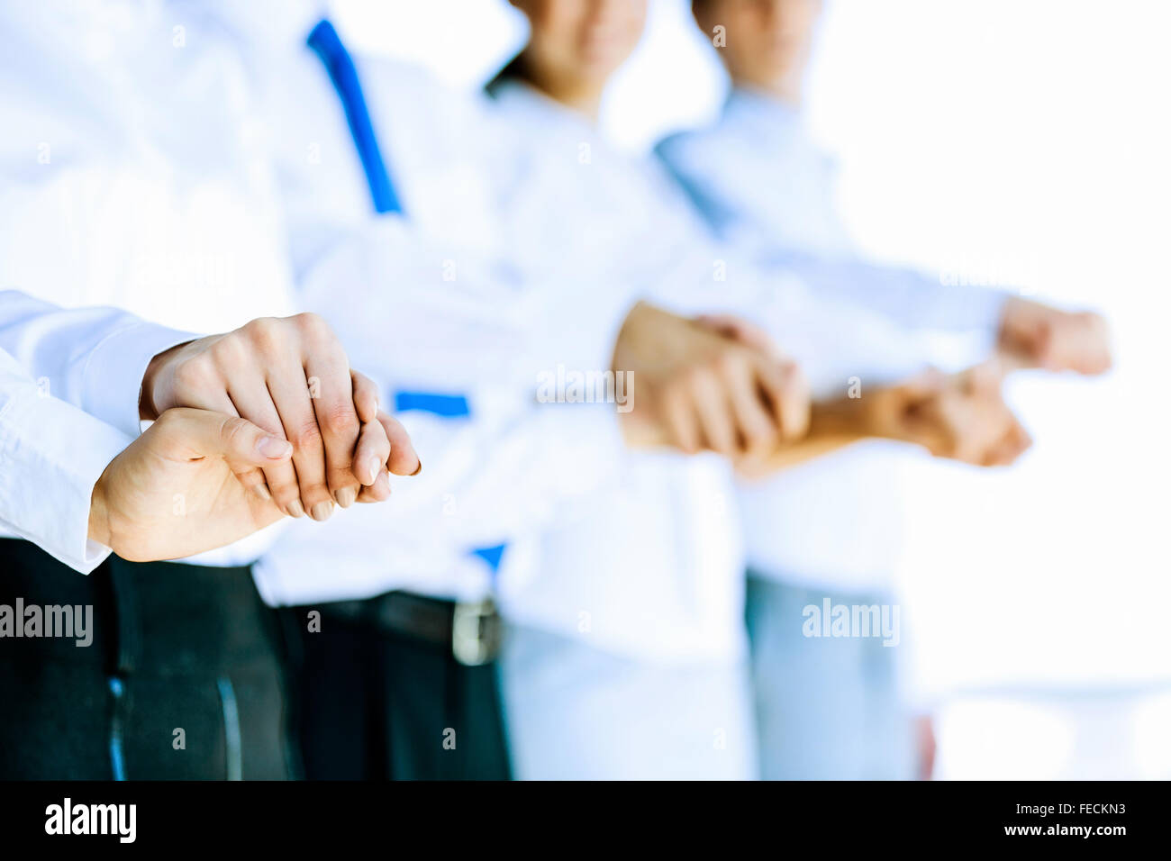 Image of group of businesspeople holding arms together. Teamwork Stock ...