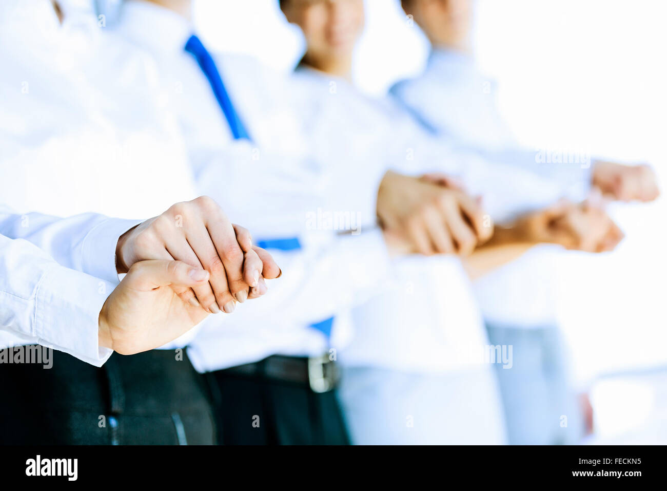 Image of group of businesspeople holding arms together. Teamwork Stock ...