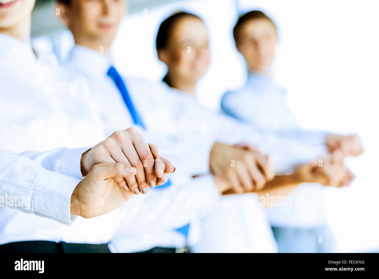 Image of group of businesspeople holding arms together. Teamwork Stock ...