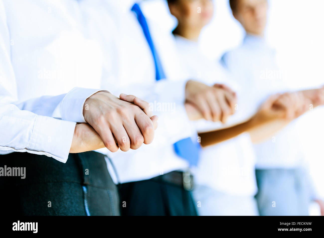 Image of group of businesspeople holding arms together. Teamwork Stock ...