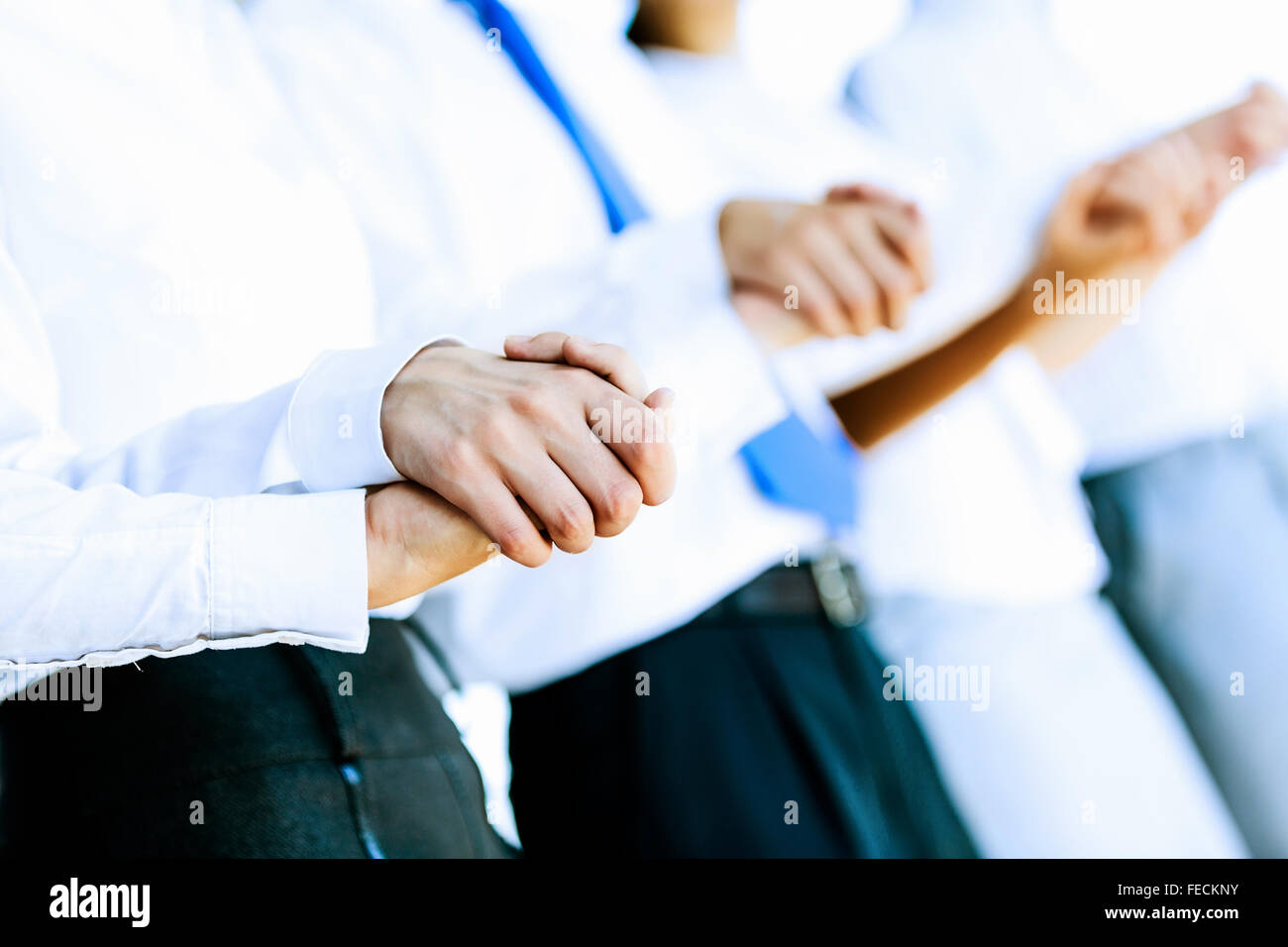 Image of group of businesspeople holding arms together. Teamwork Stock ...