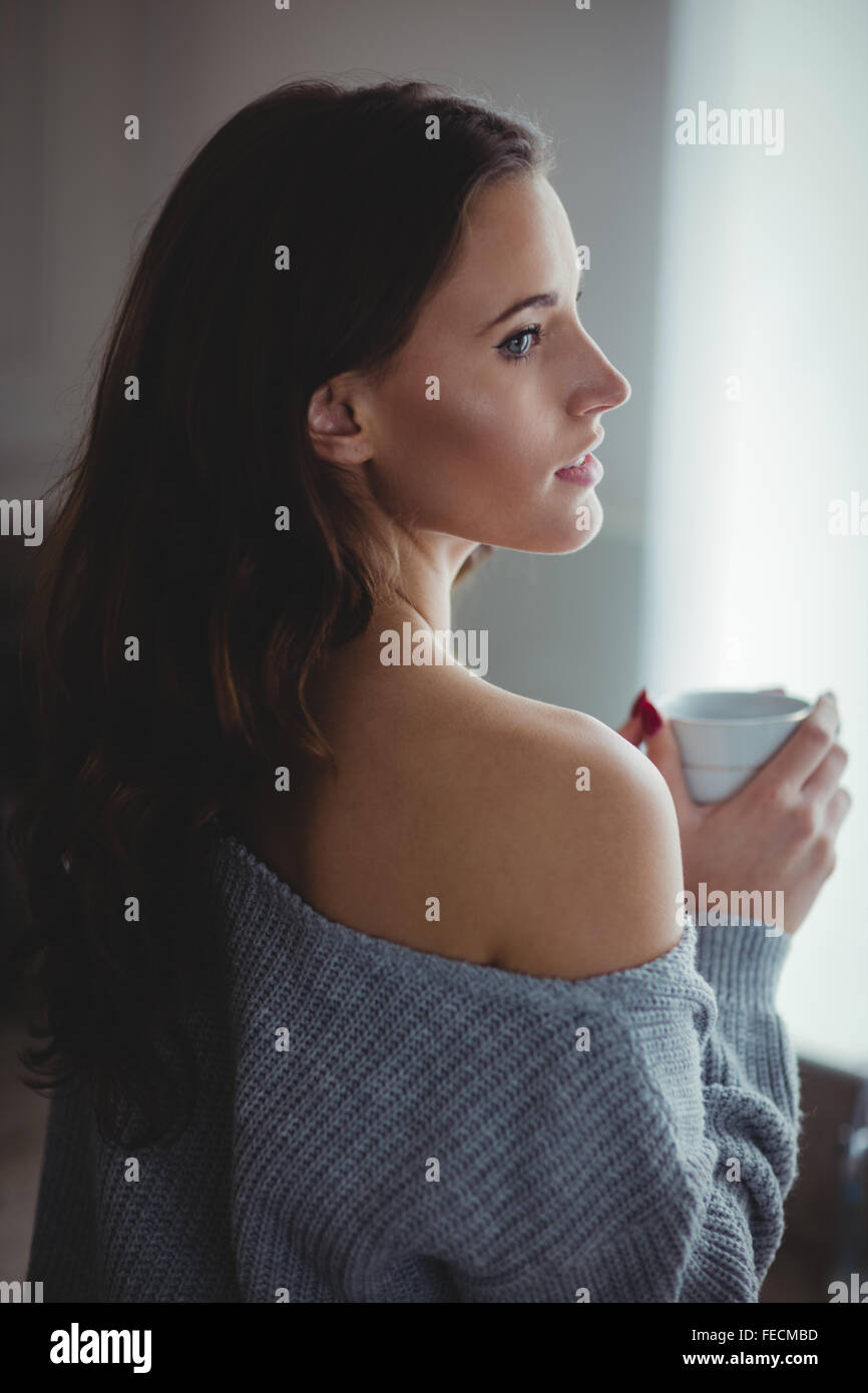 Rear view of a brunette drinking coffee Stock Photo - Alamy