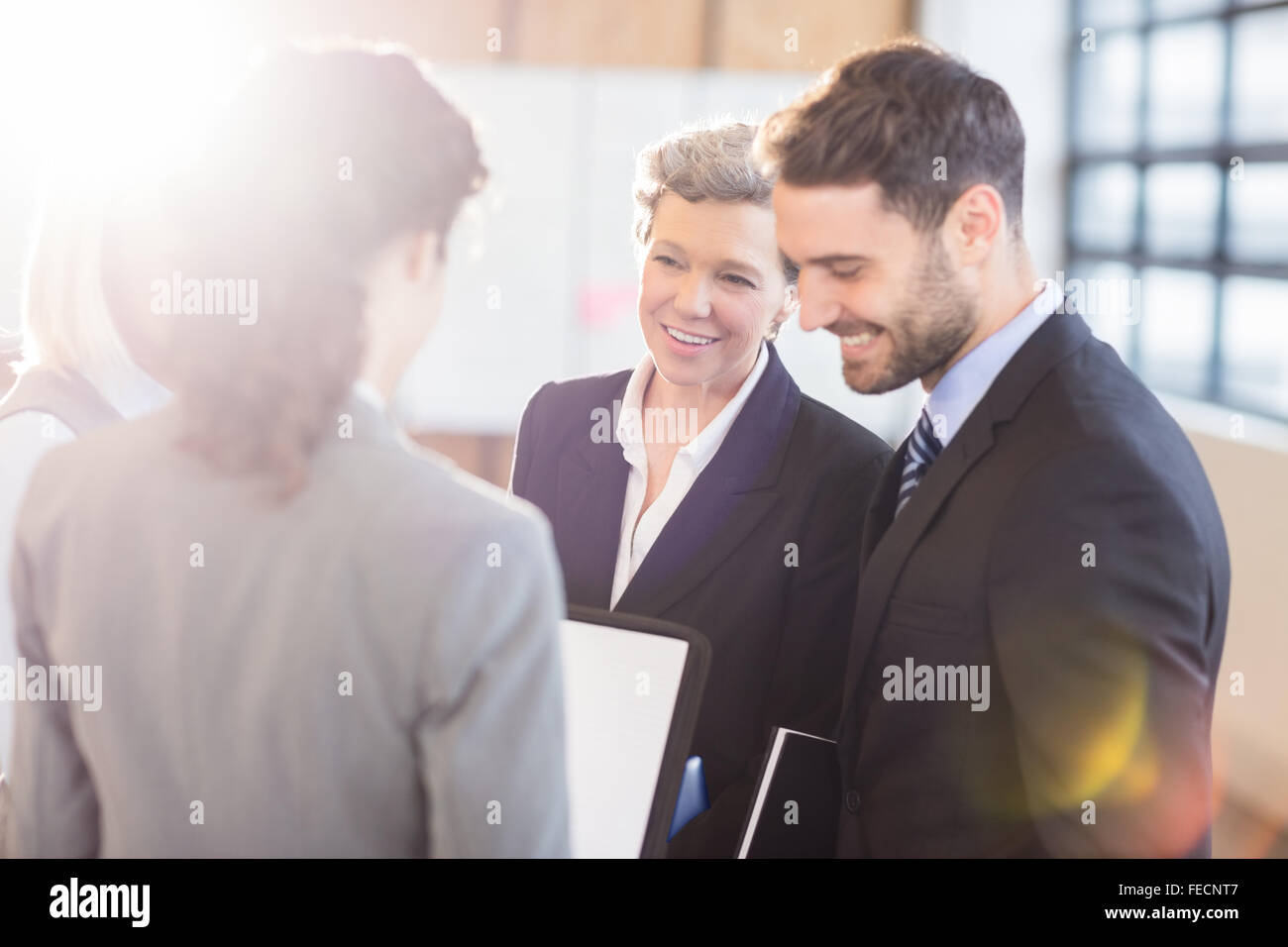 Business team standing and speaking Stock Photo - Alamy