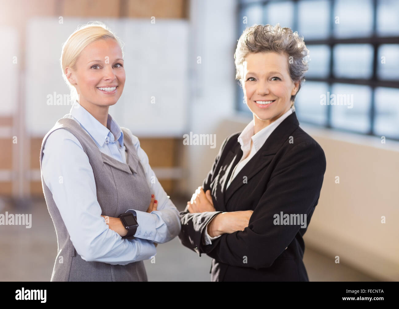 Businesswomen smiling at camera together Stock Photo - Alamy