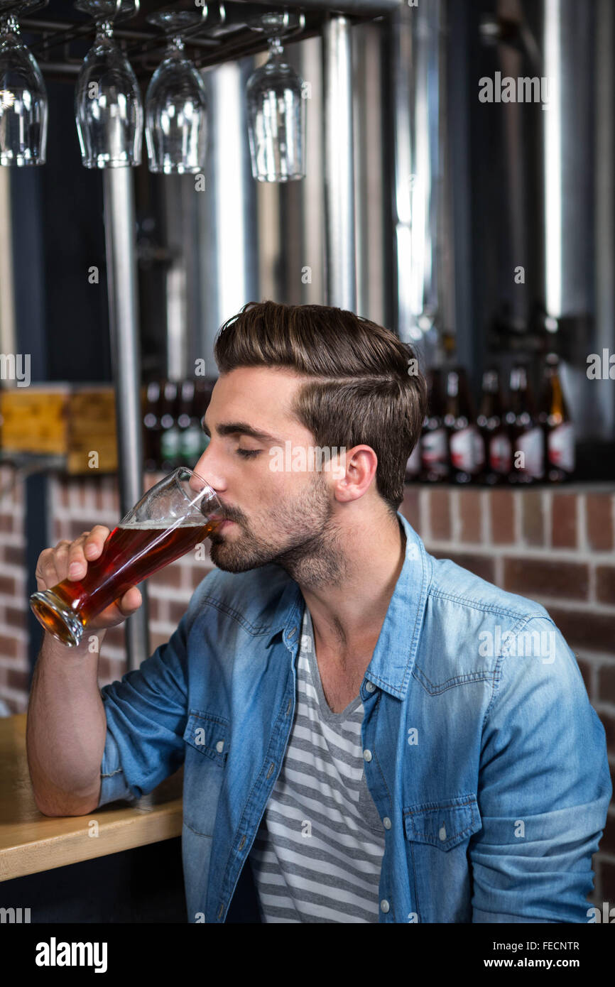 Handsome man drinking a pint of beer Stock Photo - Alamy