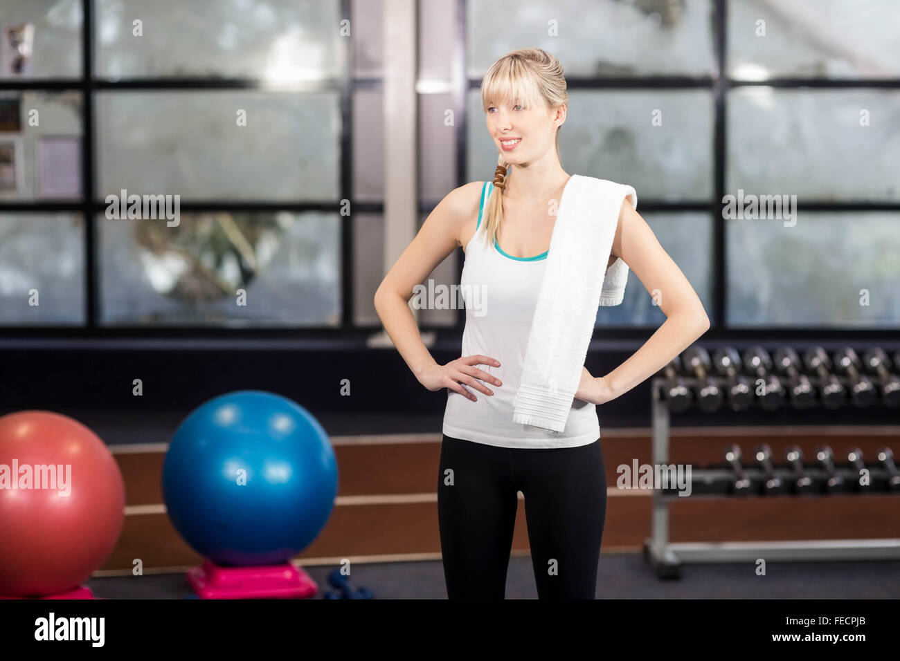 Smiling woman posing with hands on hips Stock Photo - Alamy