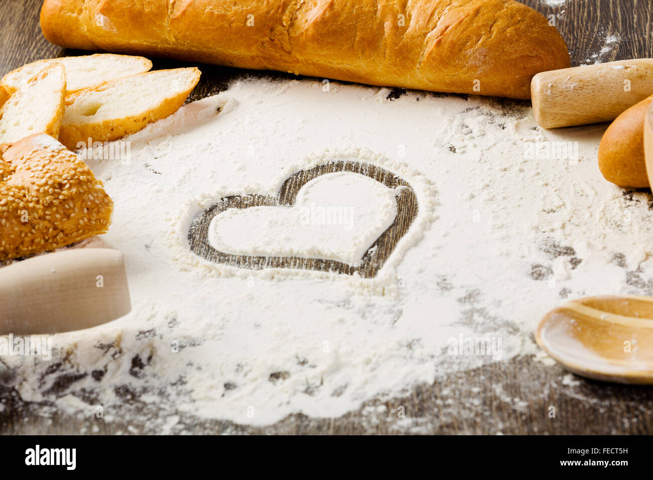White bread and flour on kitchen table Stock Photo - Alamy