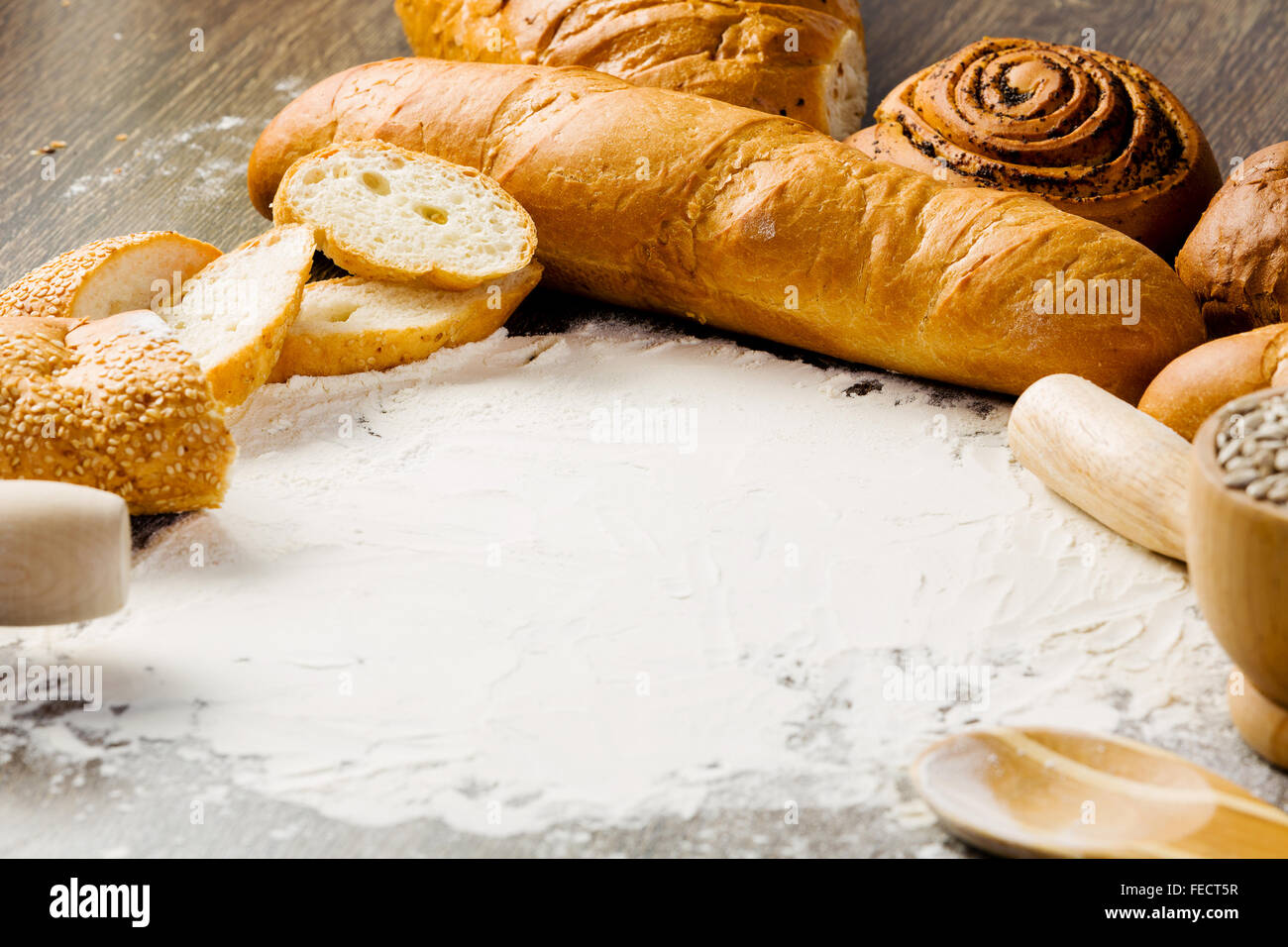 White bread and flour on kitchen table Stock Photo - Alamy