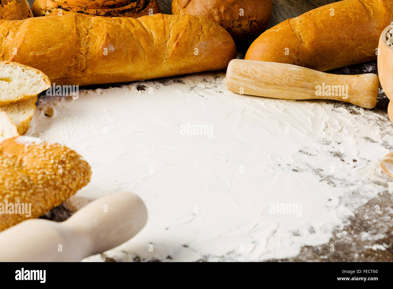 White bread and flour on kitchen table Stock Photo - Alamy