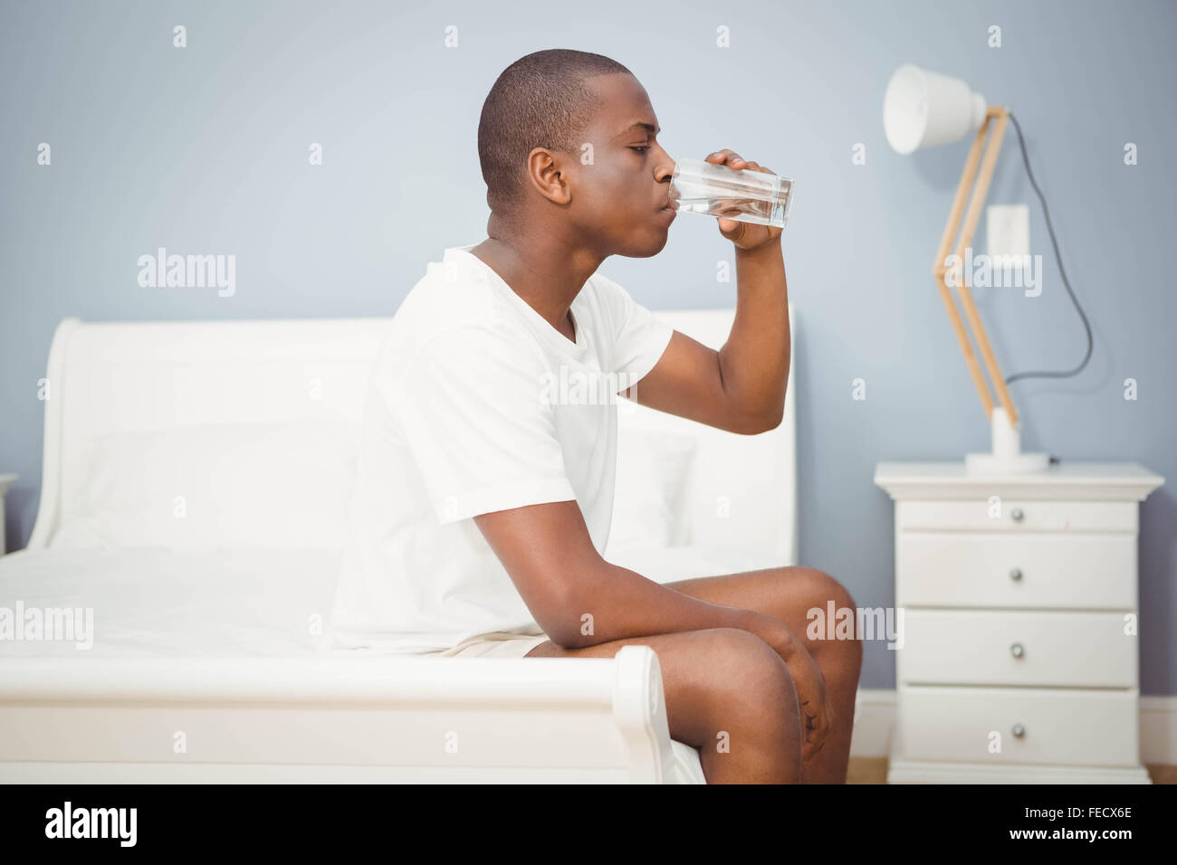 Handsome man drinking water Stock Photo - Alamy