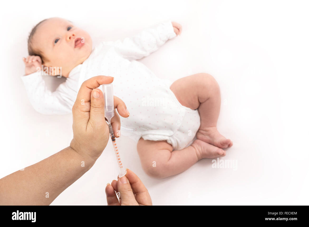 Pediatrician ready to give a one month baby girl intramuscular ...