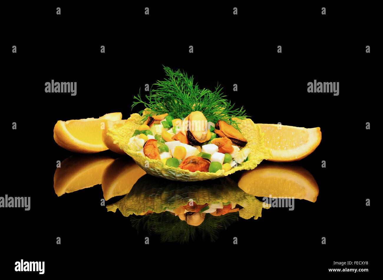 Salad of mussels with corn and peas in the leaves of savoy cabbage on a ...