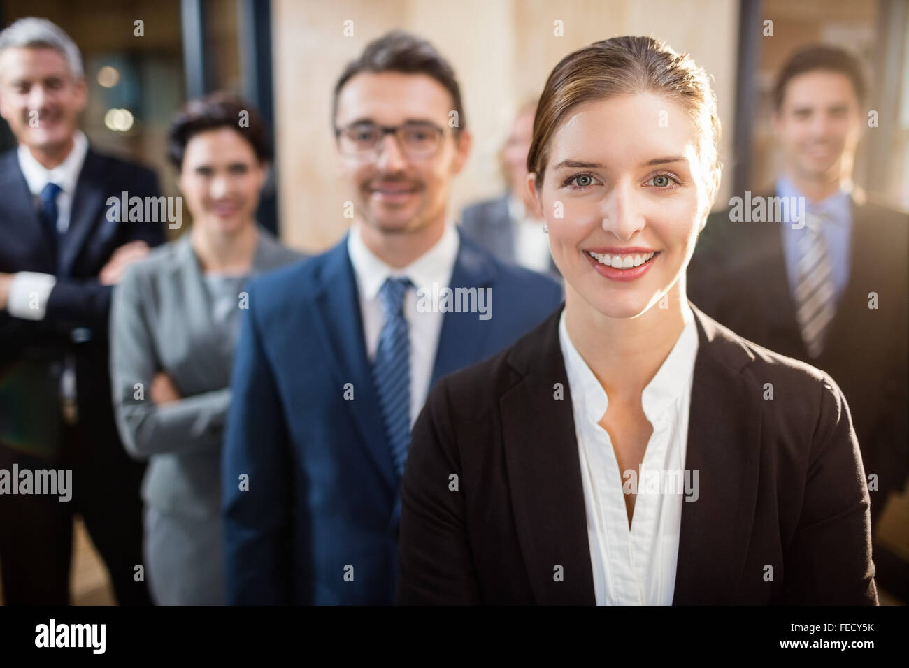 Business team smiling at the camera Stock Photo - Alamy