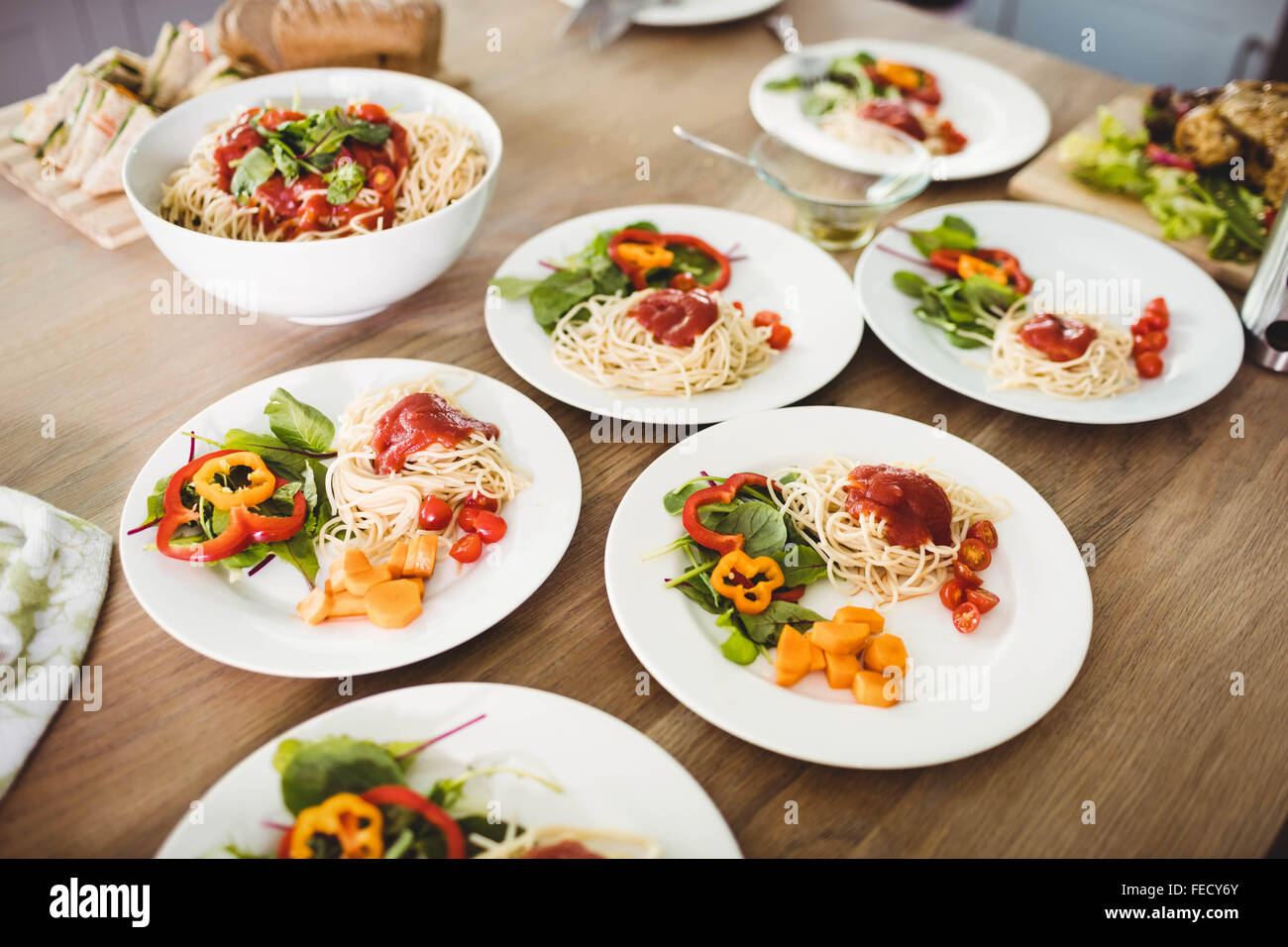 Plates of spaghetti and salad on table Stock Photo - Alamy