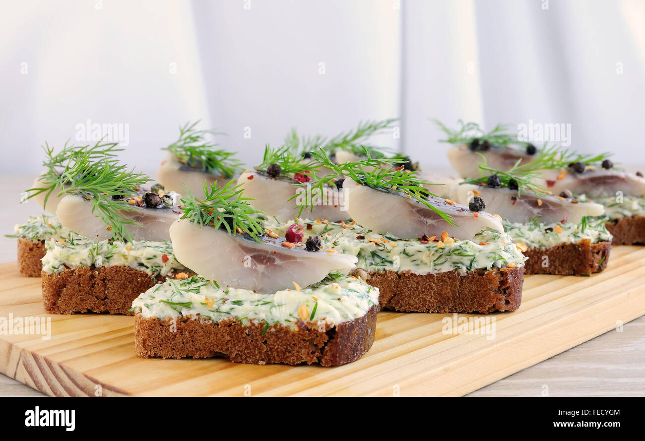 Snack rye bread with butter cream with herbs and spices herring Stock ...