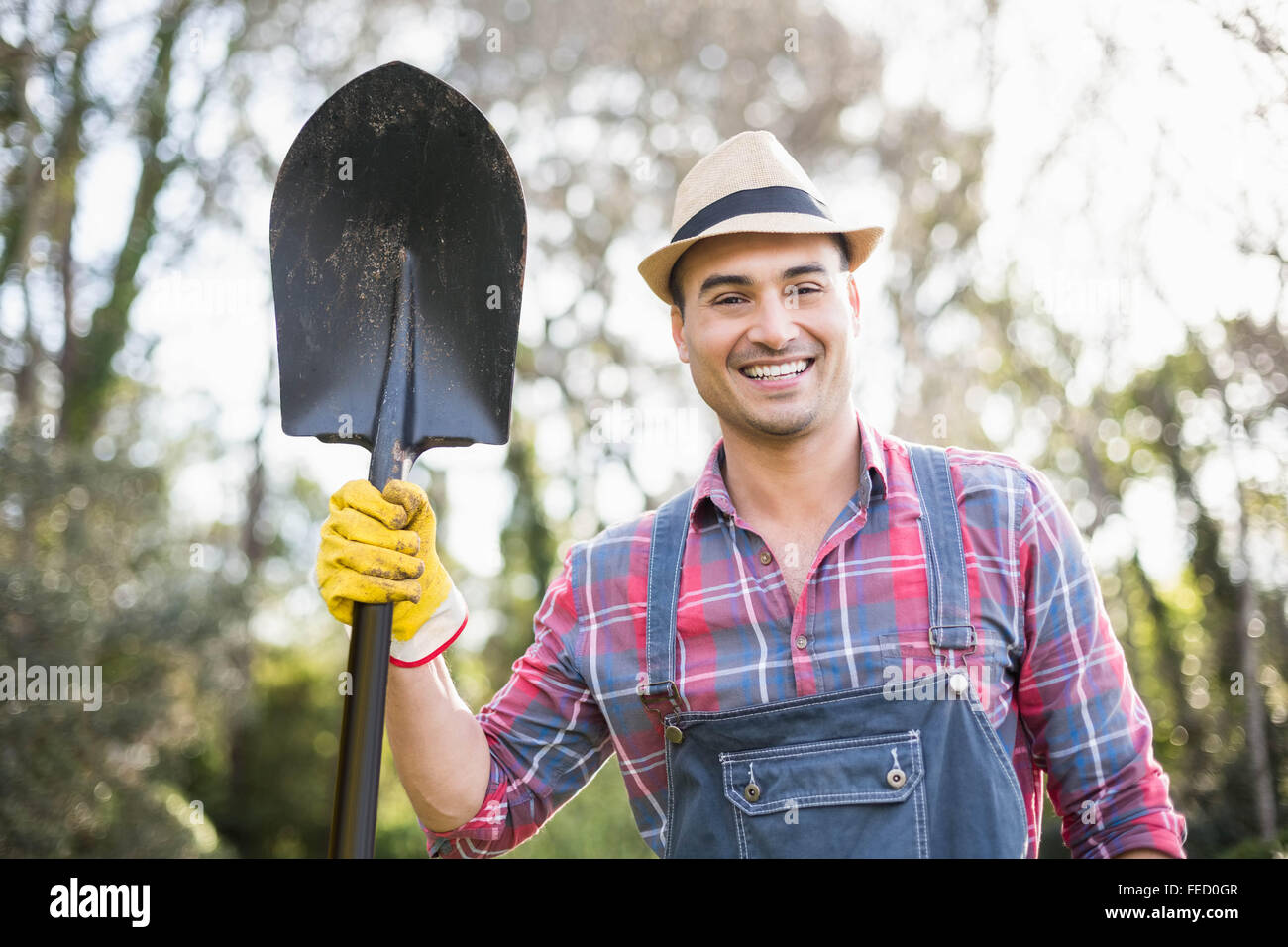 Gardener man posing with his shovel Stock Photo - Alamy
