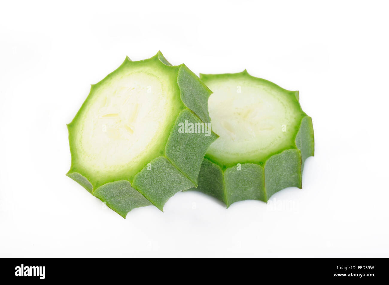 sliced angled loofah on white background Stock Photo - Alamy