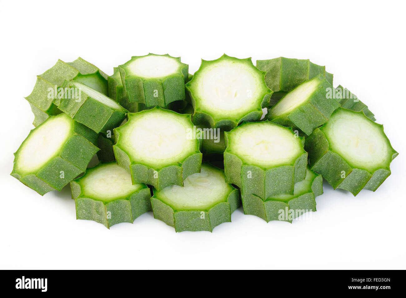 sliced angled loofah on white background Stock Photo - Alamy