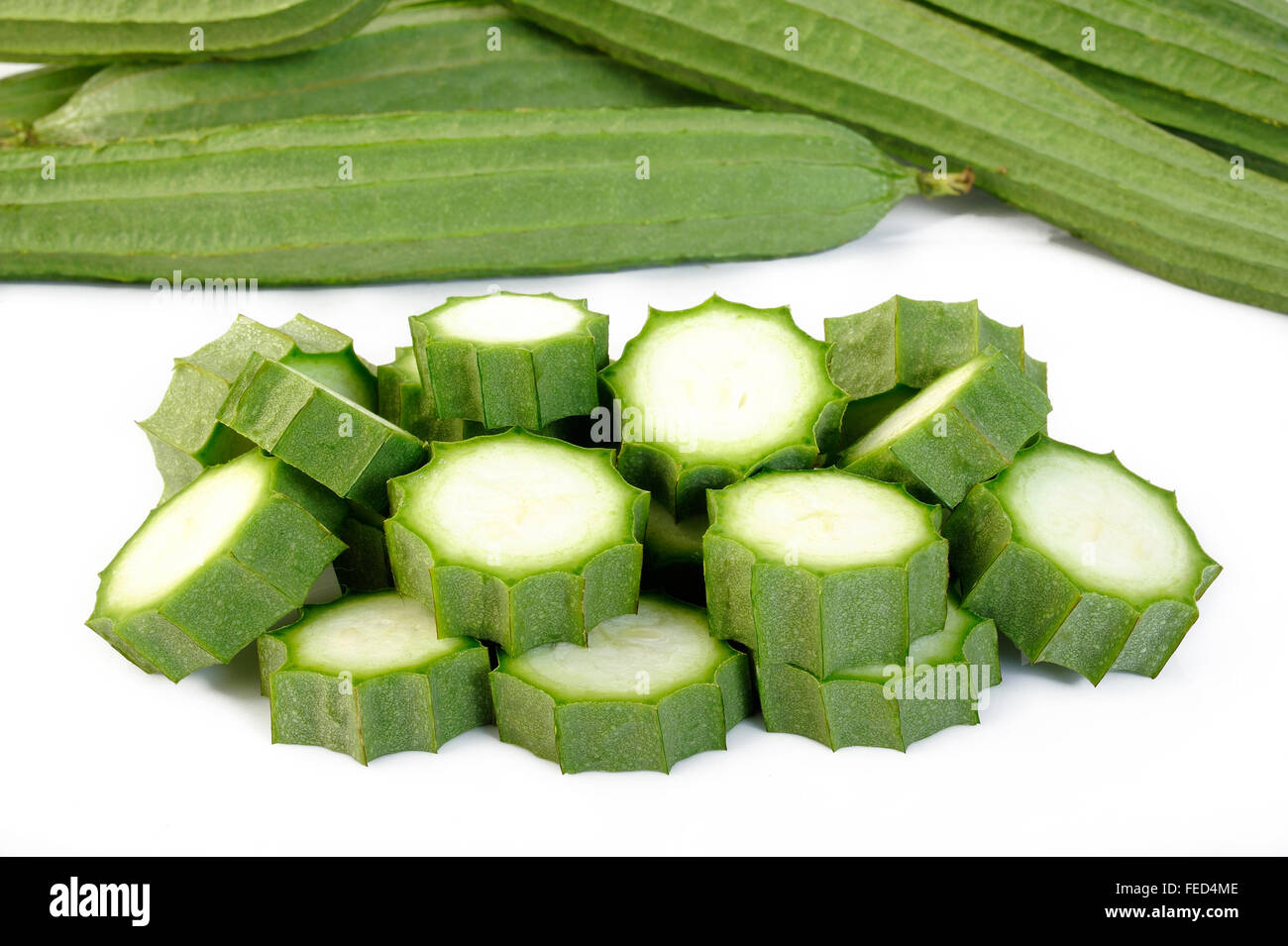 sliced angled loofah on white background Stock Photo - Alamy