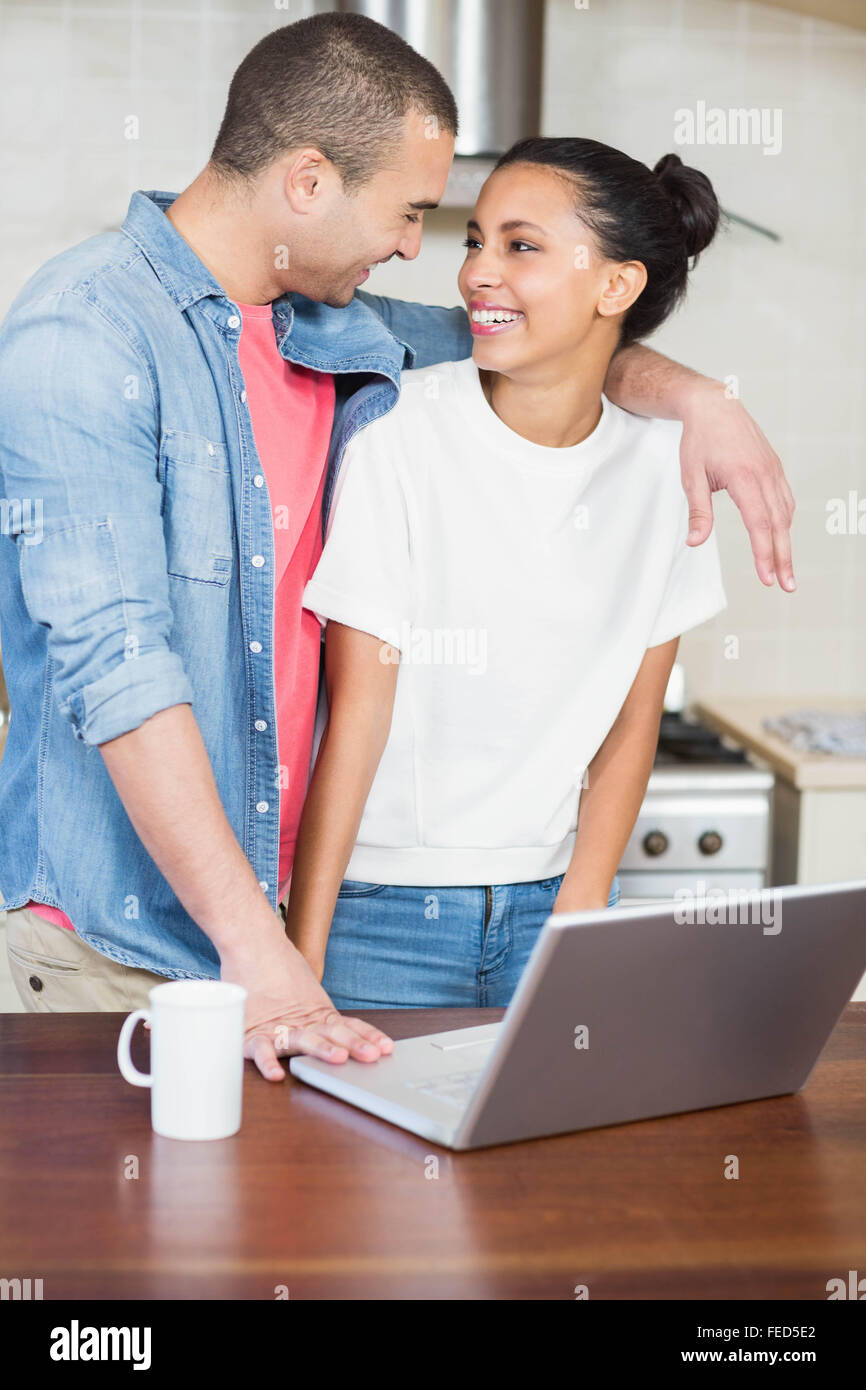 Smiling couple using laptop Stock Photo - Alamy