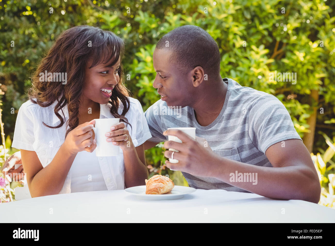 Ethnic couple having a mug of tea Stock Photo - Alamy