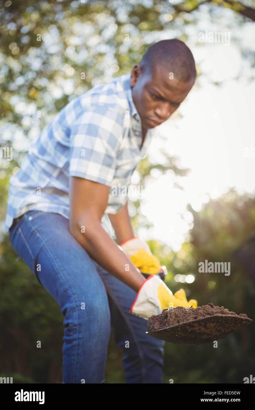 Handsome man digging with a shovel Stock Photo - Alamy