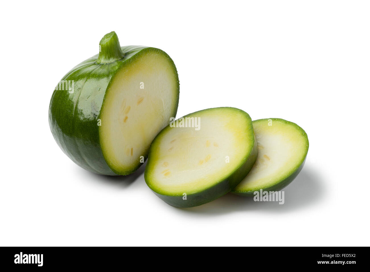 Fresh round zucchini with slices on white background Stock Photo - Alamy