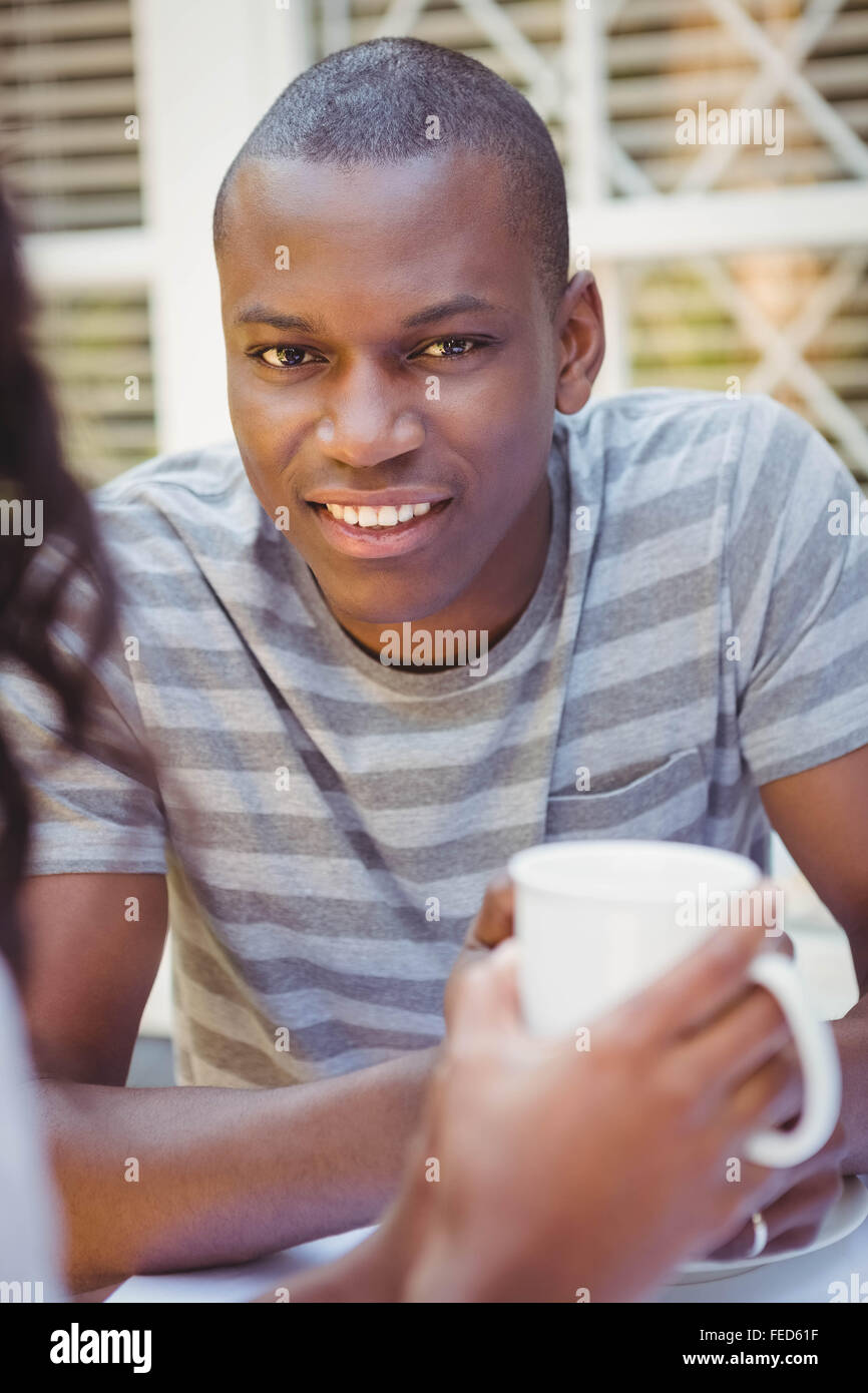 Handsome man having a mug of tea with his girlfriend Stock Photo - Alamy