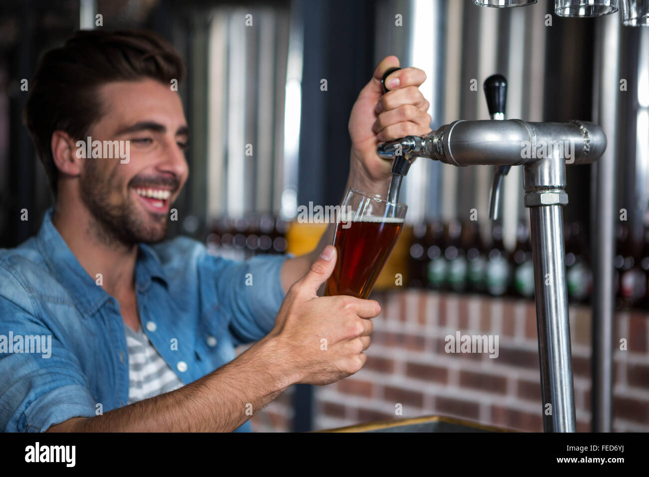 Barman pouring beer Stock Photo - Alamy