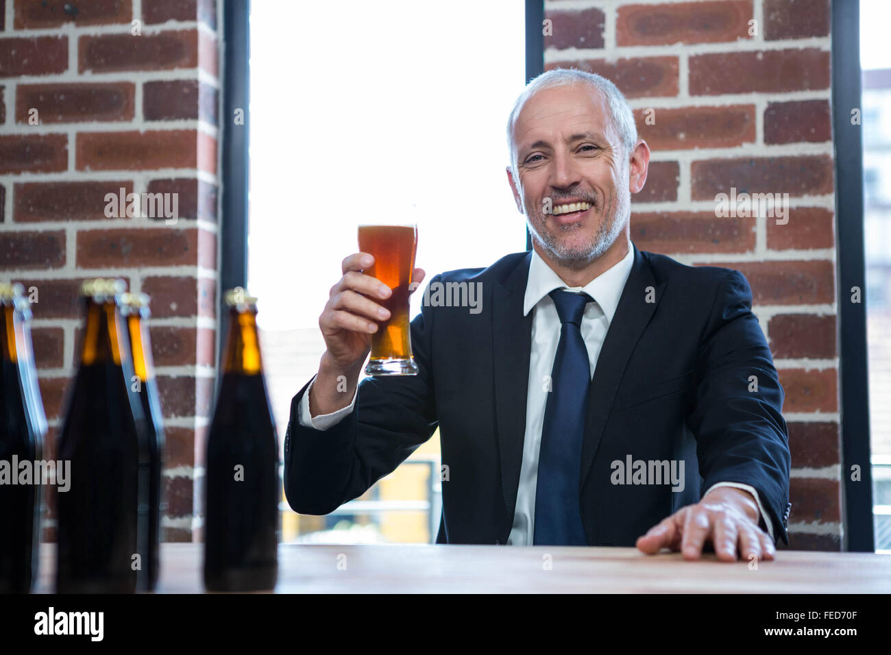 Businessman drinking a beer Stock Photo - Alamy