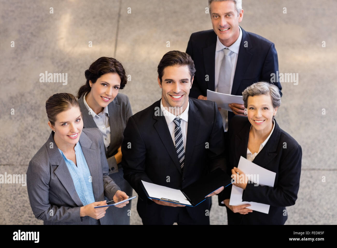 Business team smiling at the camera Stock Photo - Alamy