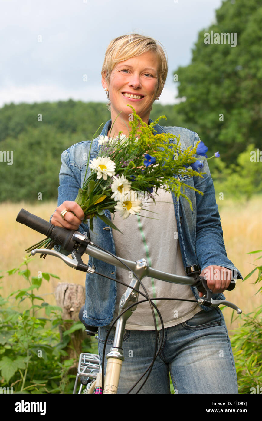 Woman pushing a bicycle hi-res stock photography and images - Alamy