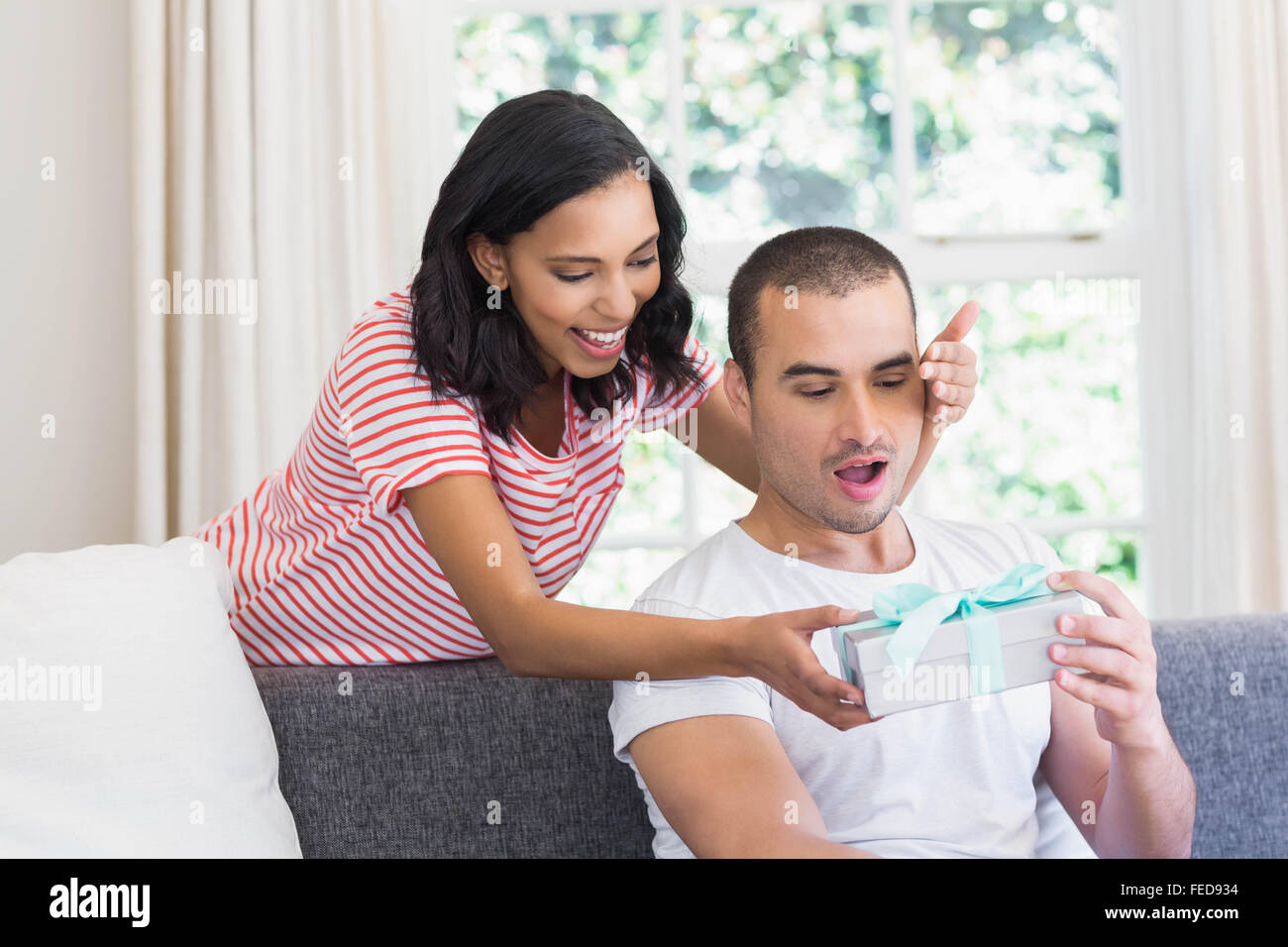Happy couple receiving a gift Stock Photo - Alamy