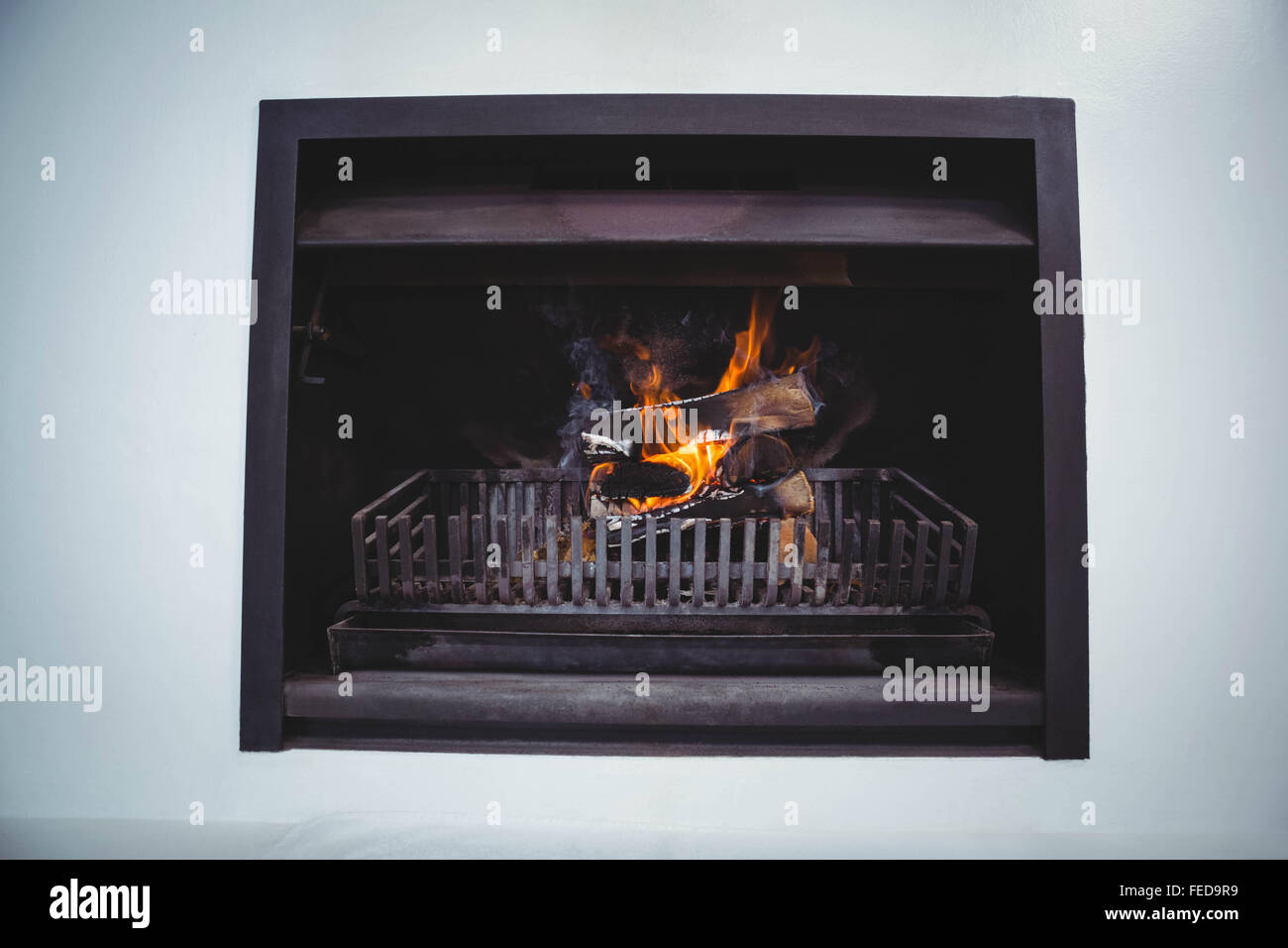 Fireplace set in wall Stock Photo - Alamy
