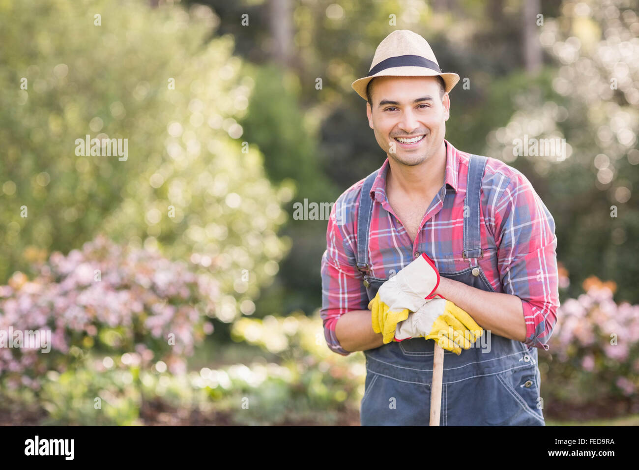 Gardener man posing with his rake Stock Photo - Alamy