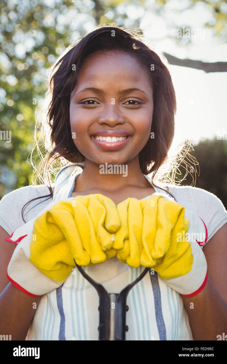 Pretty woman holding a shovel Stock Photo - Alamy