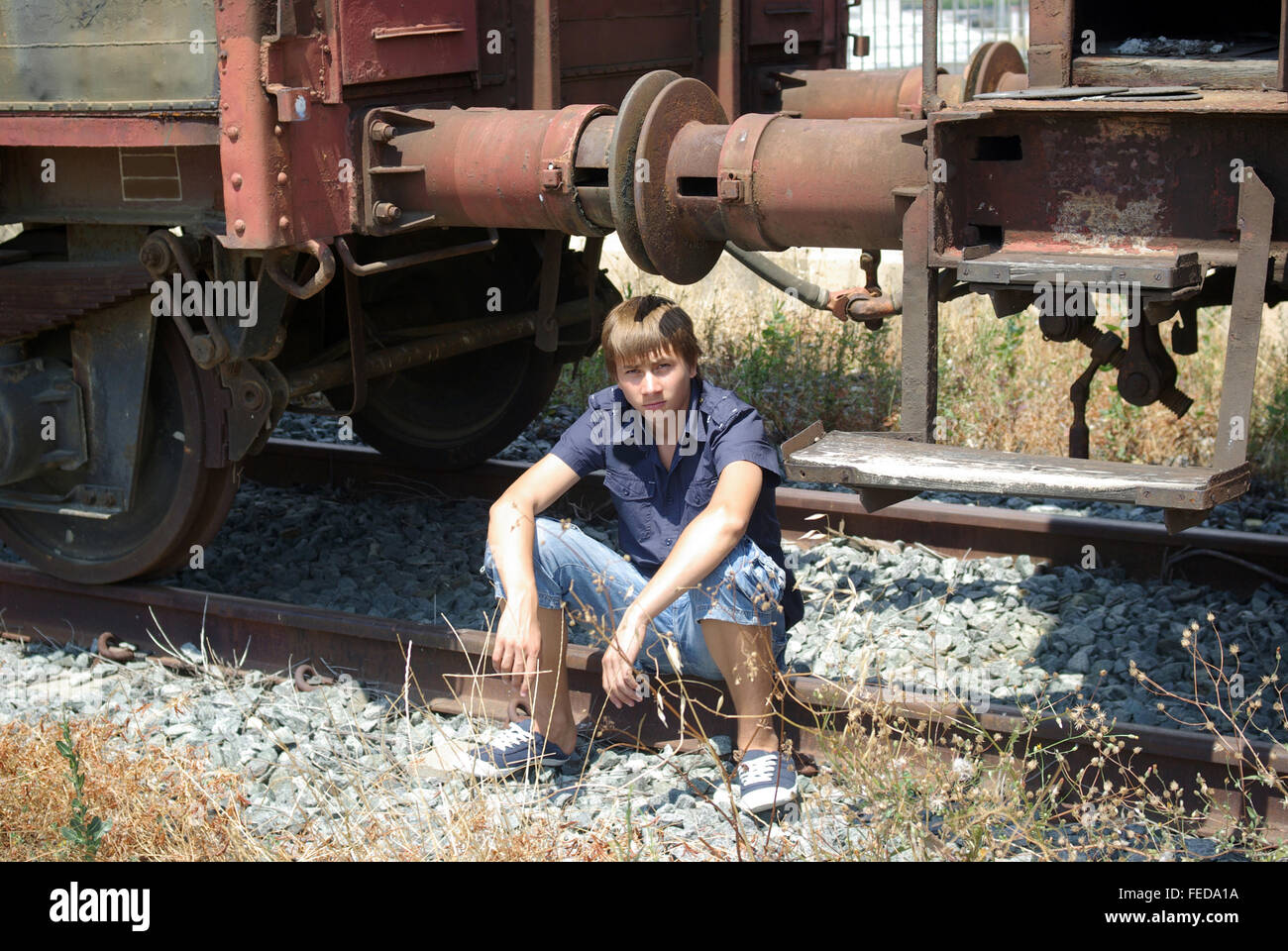Boy in abandoned train station Stock Photo - Alamy