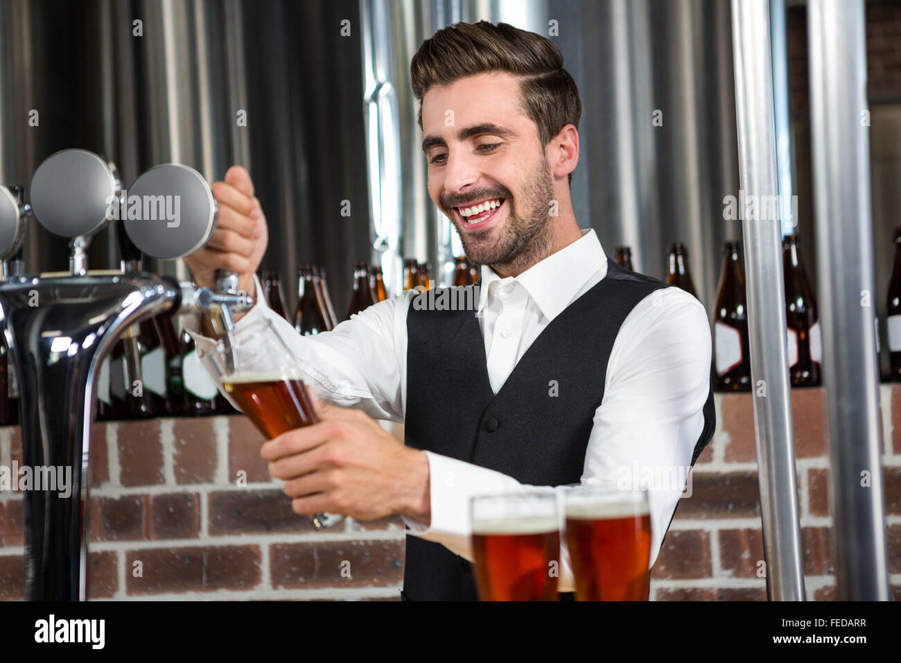 Handsome barman pouring a pint of beer Stock Photo - Alamy