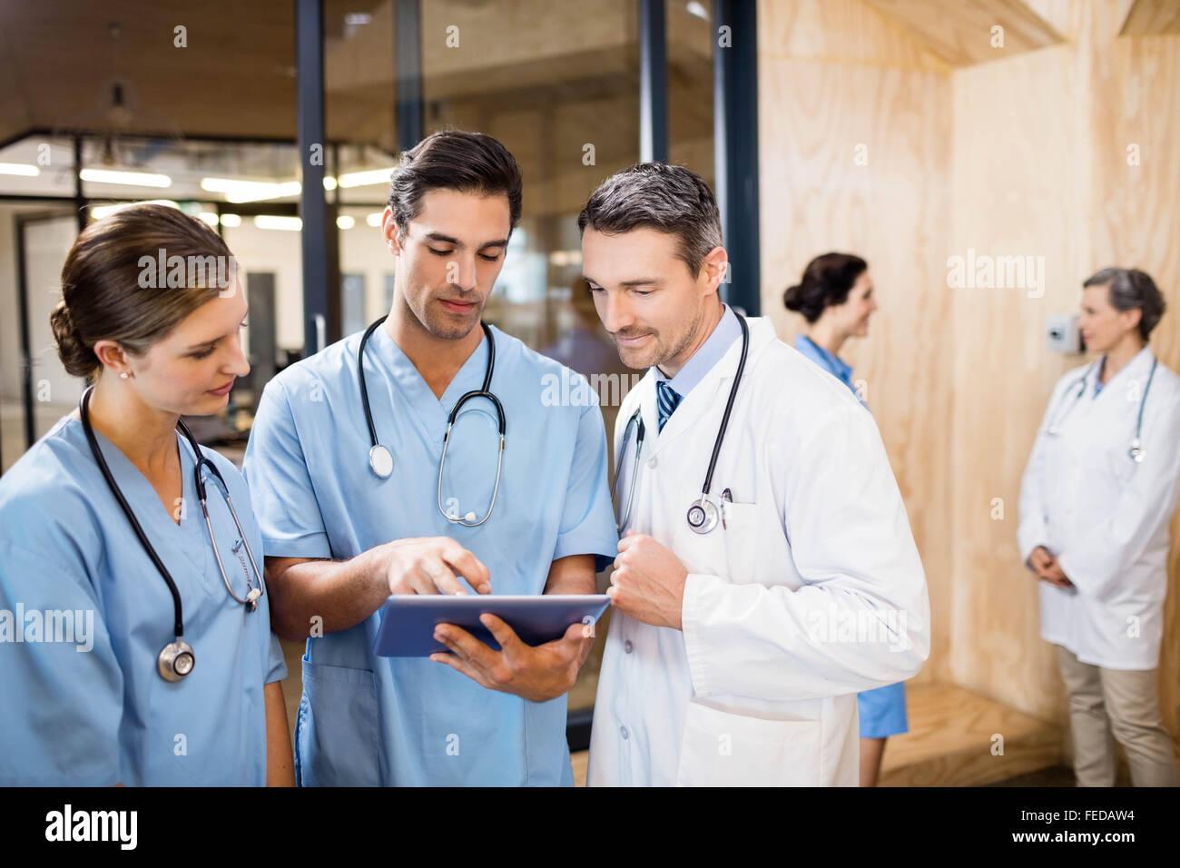 Medical team standing and talking Stock Photo - Alamy