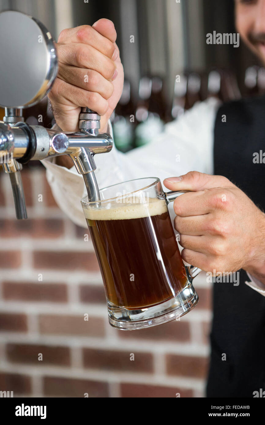 Barman pouring beer Stock Photo - Alamy