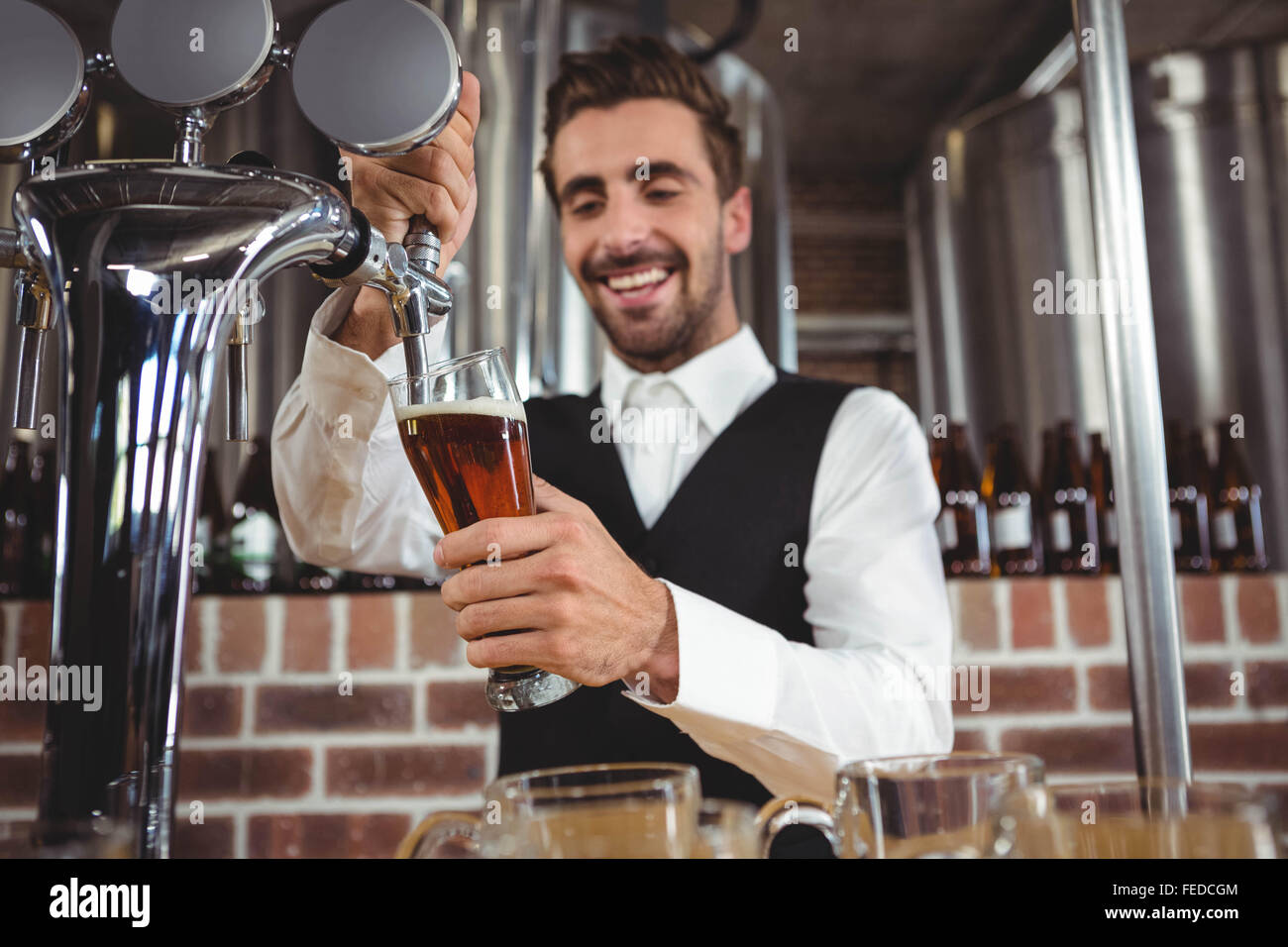 Handsome barman pouring beer Stock Photo - Alamy