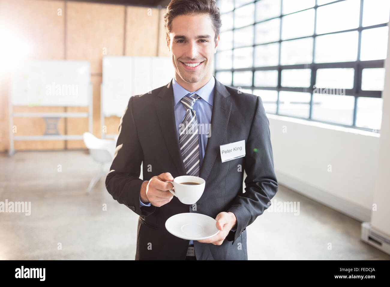 Businessman smiling at conference Stock Photo - Alamy