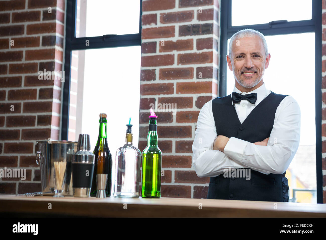 Bar tender crossing arms Stock Photo - Alamy