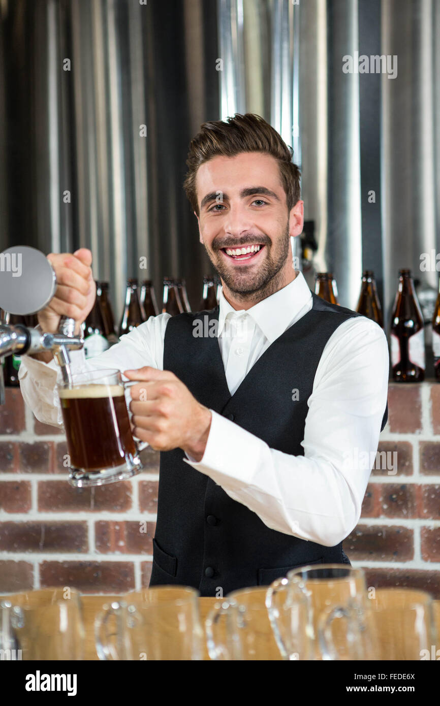 Barman pouring beer Stock Photo - Alamy
