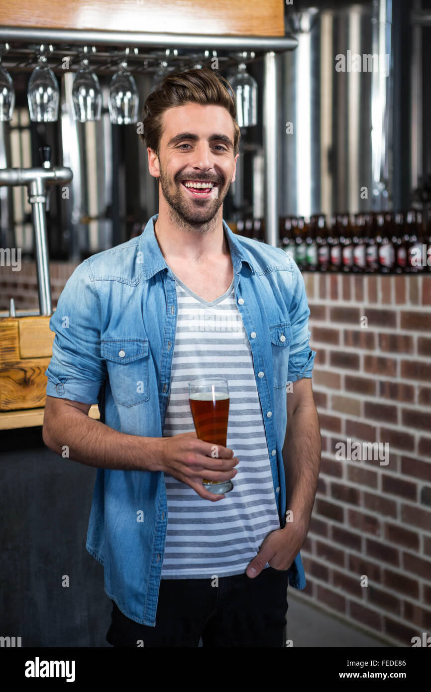 Handsome man holding his pint Stock Photo - Alamy
