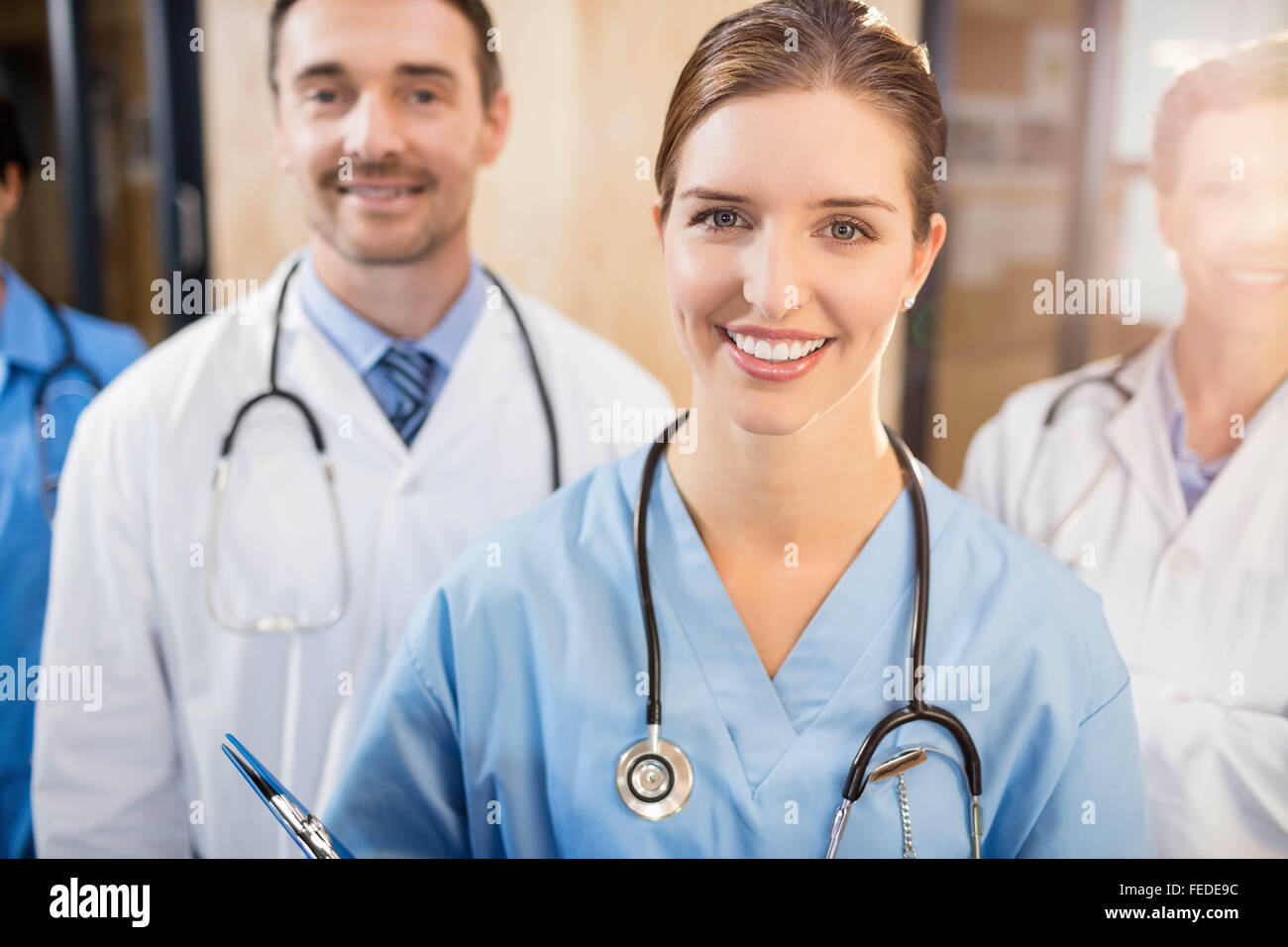 Medical team smiling at camera together Stock Photo - Alamy