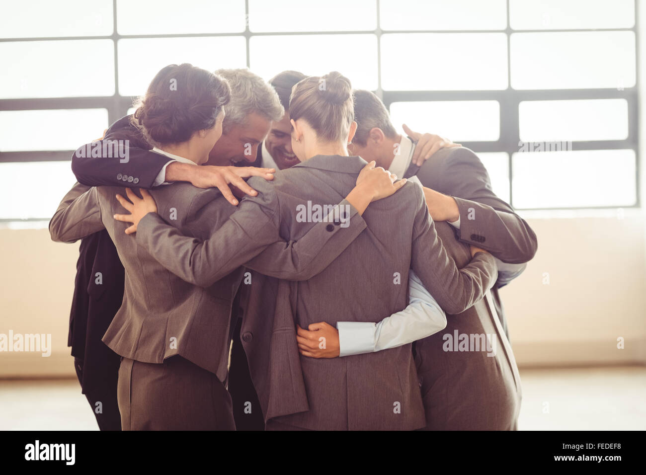 Business team huddling Stock Photo - Alamy